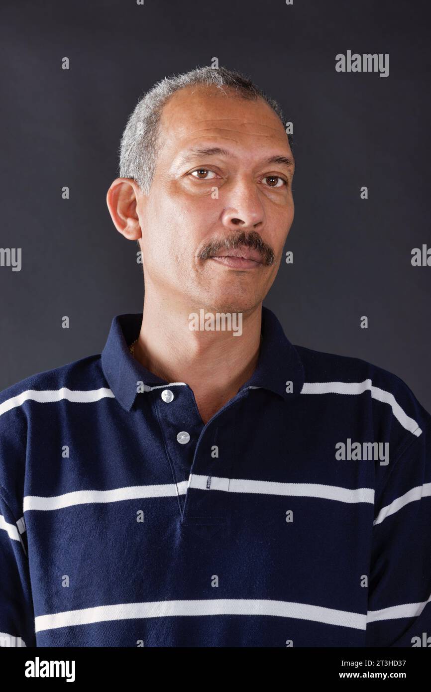 studio portrait of a cuban man in his fifties, dark background Stock ...