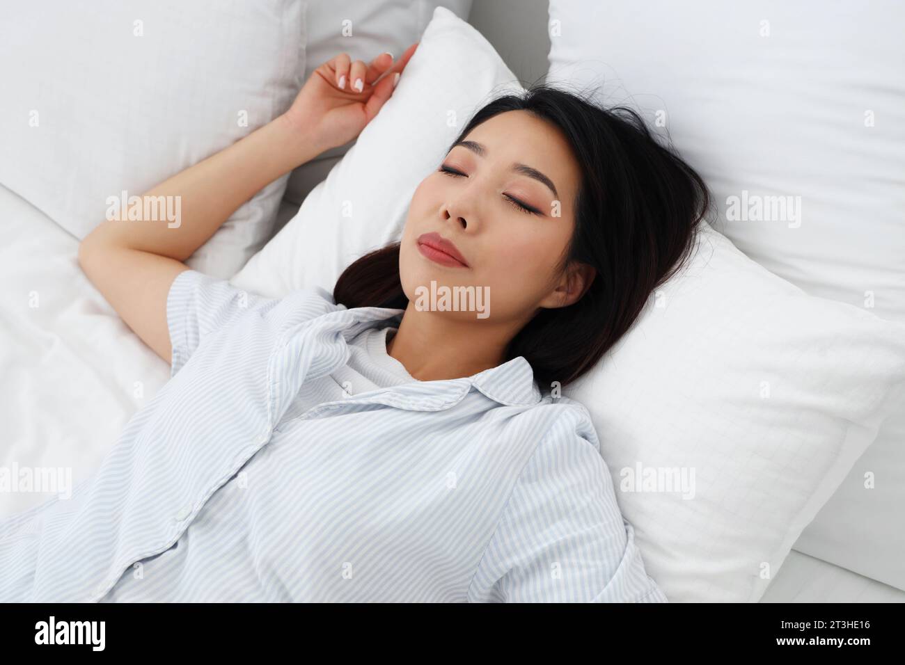 Beautiful Asian woman sleeping in bed, closeup Stock Photo - Alamy