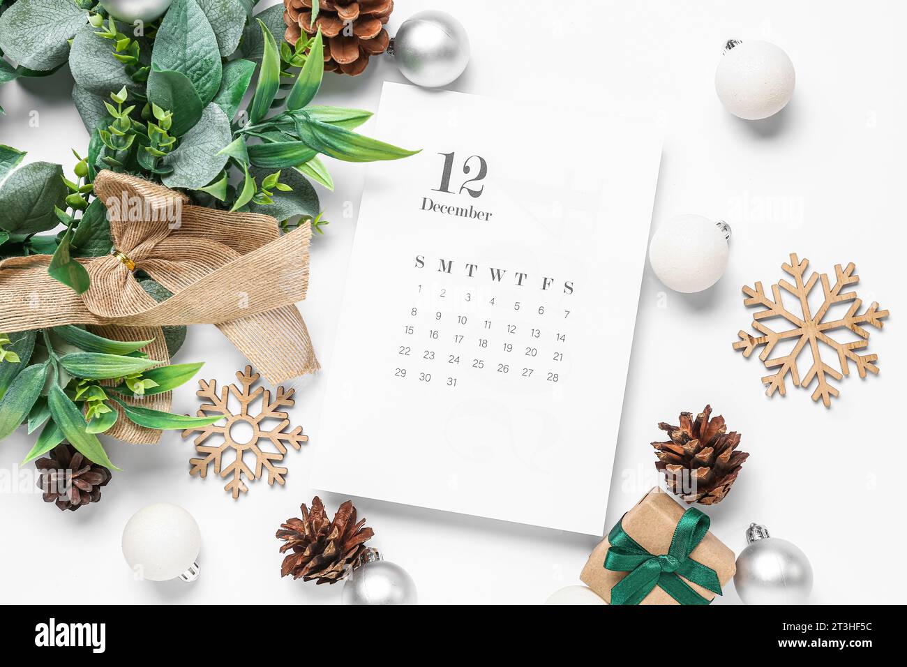 Paper calendar for December 12 with mistletoe wreath, gift box and ...
