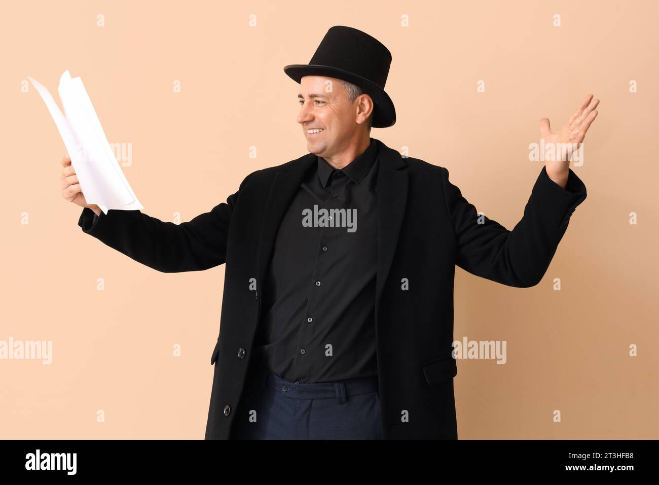 Mature actor reading film script on beige background Stock Photo - Alamy