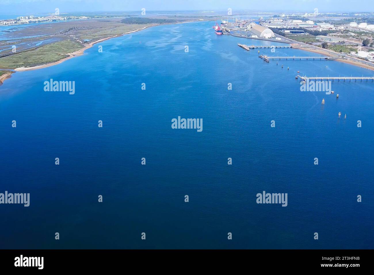 Flying over the Odiel river through the outer port of Huelva industrial ...