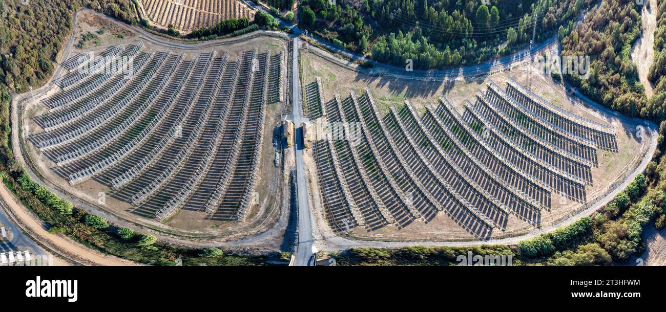 Aerial panoramic drone view of a farm of solar panels between crop ...