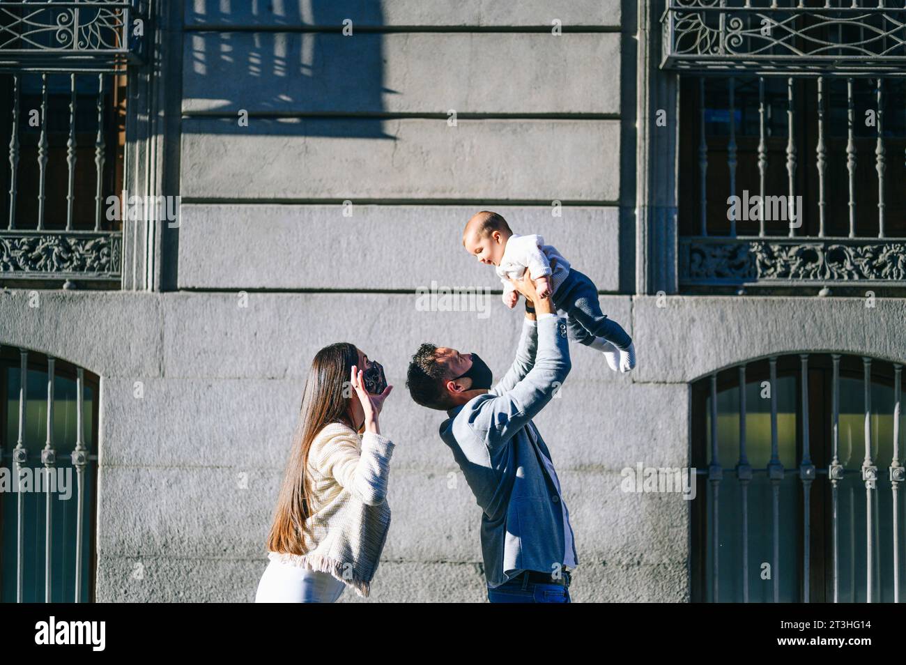 Happy family together, parents with their little child Father raising ...