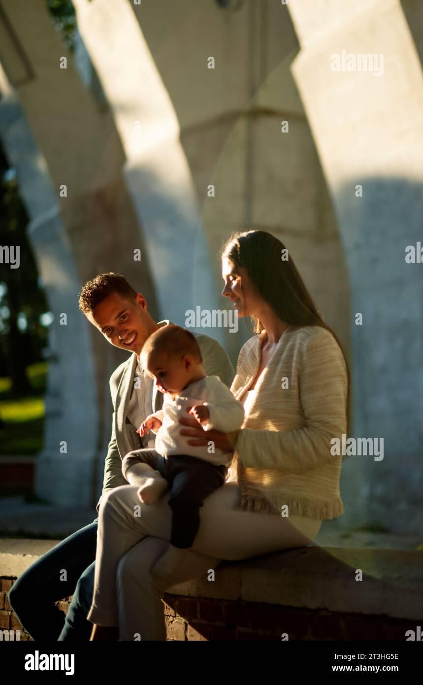 happy parents with their child in their lap Stock Photo - Alamy