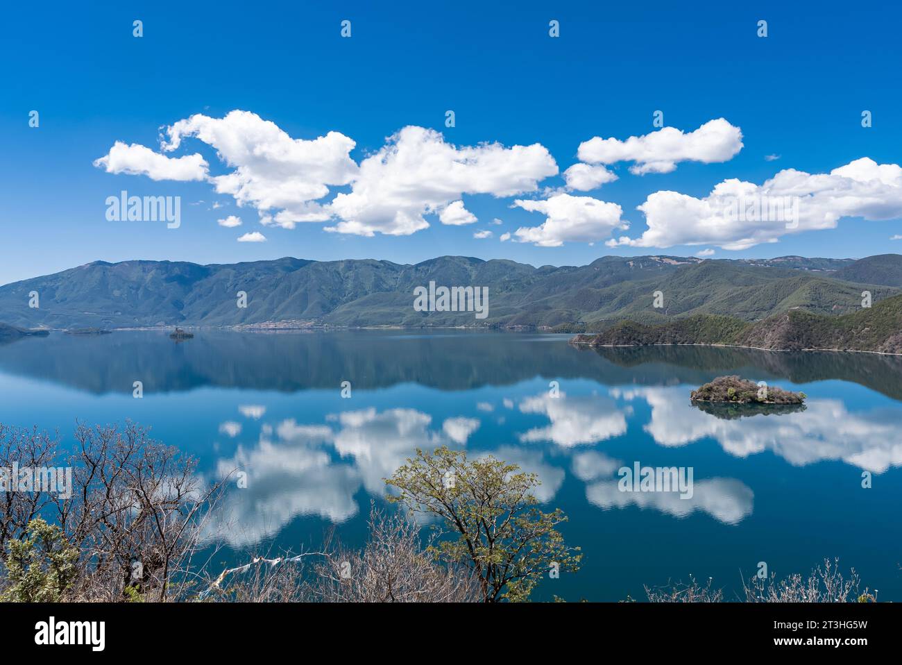 The reflection of blue sky and white clouds on the water surface of ...