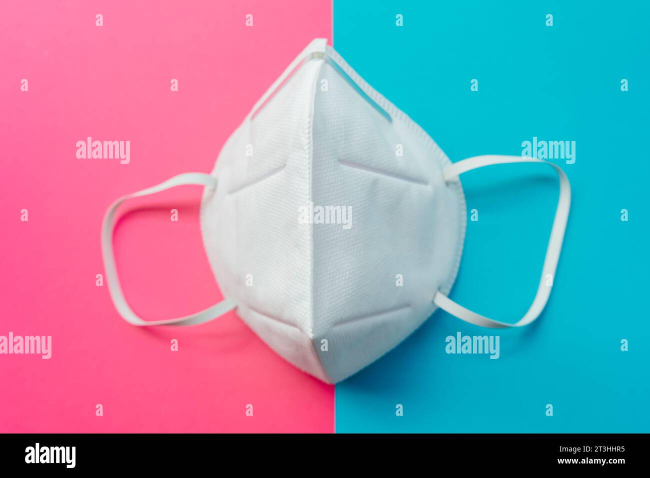 Standard ffp2 virus protection mask to prevent COVID-19. Half pink and ...