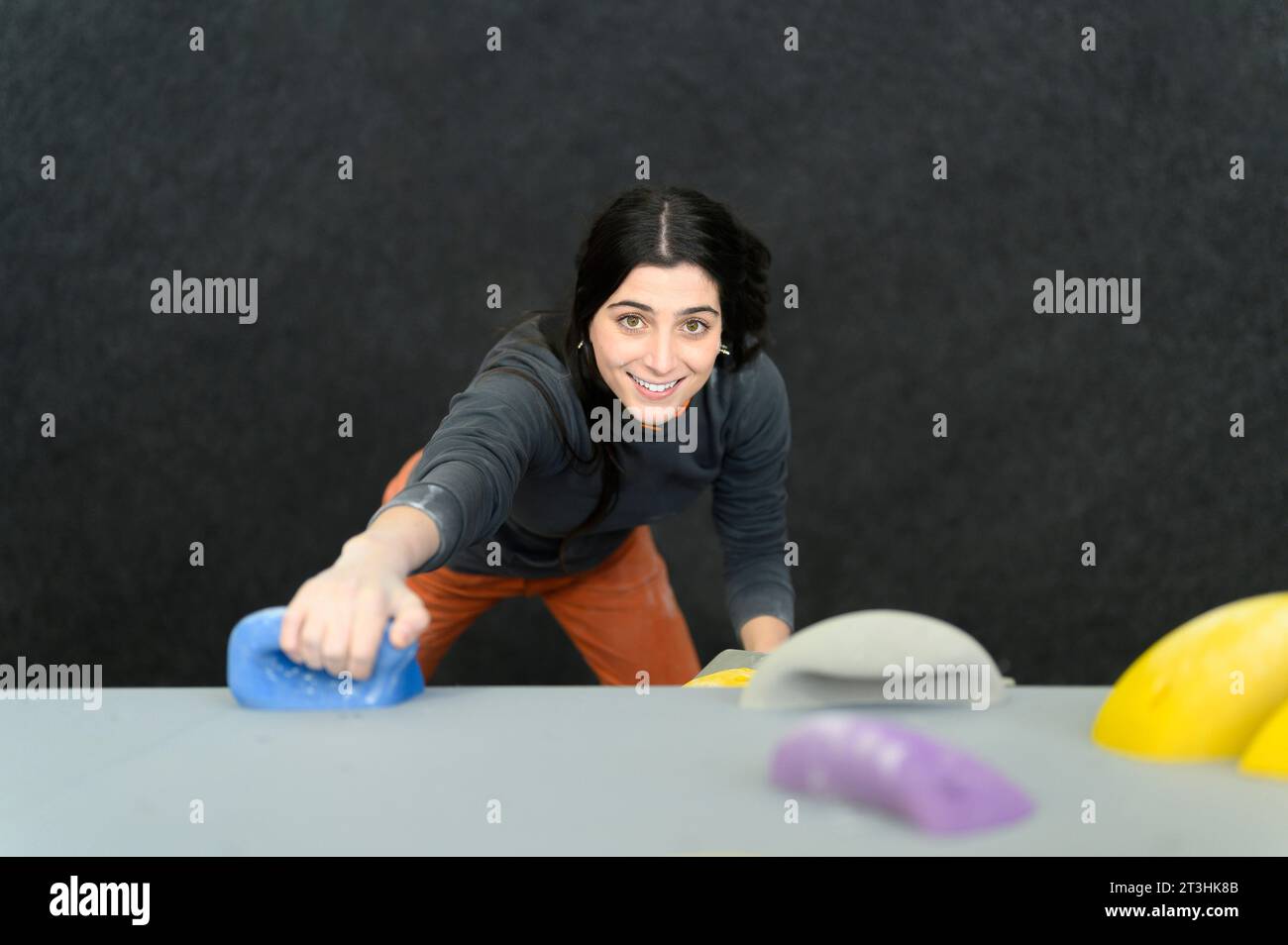 View of professional climber woman climbing on practical wall indoor ...