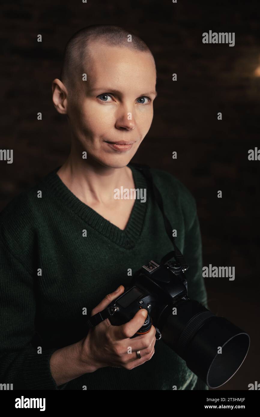 A professional female photographer with a camera in hand, capturing ...