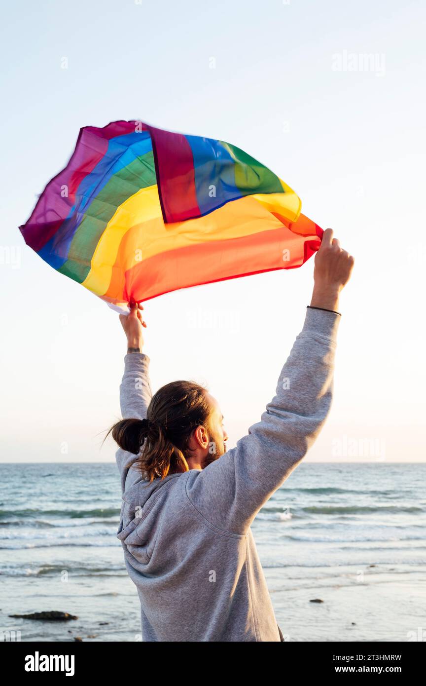 Person holding a gay pride flag hi-res stock photography and images - Alamy