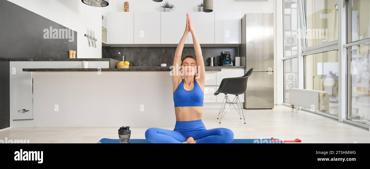 Raised Hands Pose. Urdhva Hastasana. Young fitness woman sits on yoga ...