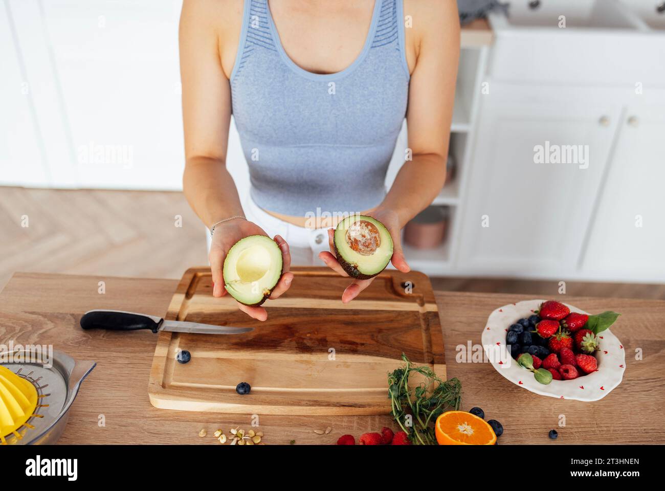 An attractive cute Asian woman smiles and cooks breakfast in the ...