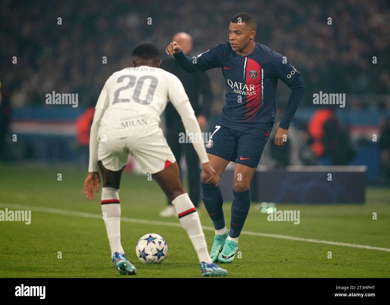 PSG's Kylian Mbappe (right) in action against AC Milan's Pierre Kalulu ...