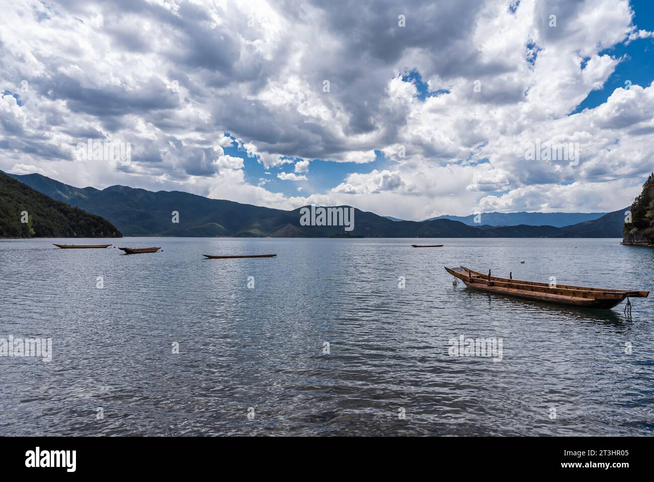 Pig trough boats on the surface of Lugu Lake in China Stock Photo - Alamy