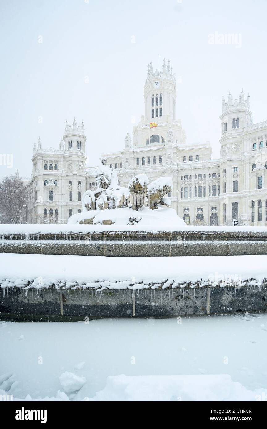 fountain at the Plaza de Cibeles in Madrid covered in snow after the ...