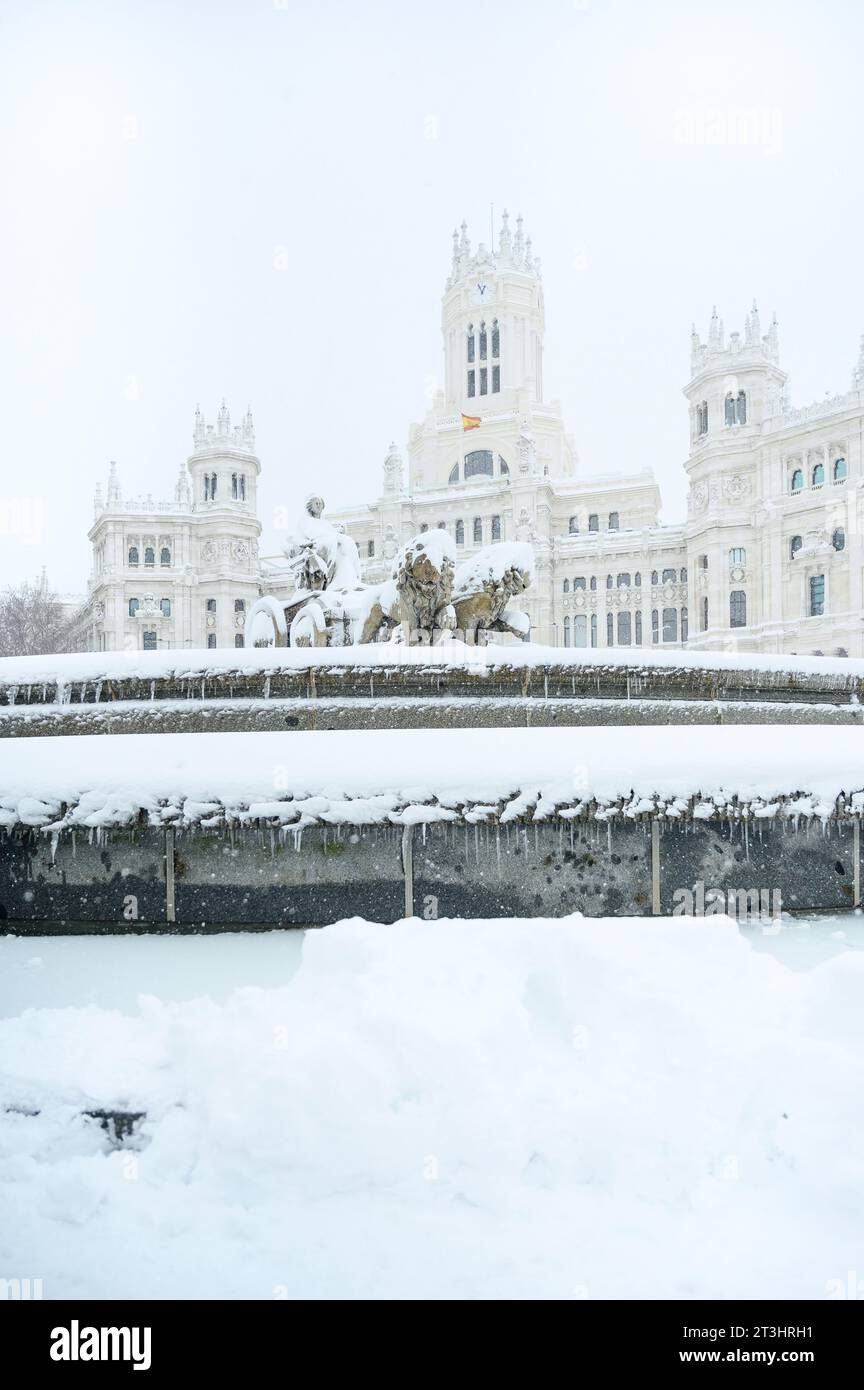 fountain at the Plaza de Cibeles in Madrid covered in snow after the ...