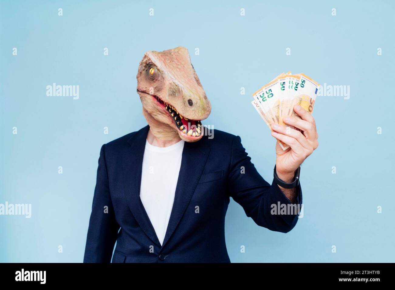 Attractive man with dinosaur mask holding his money Stock Photo - Alamy
