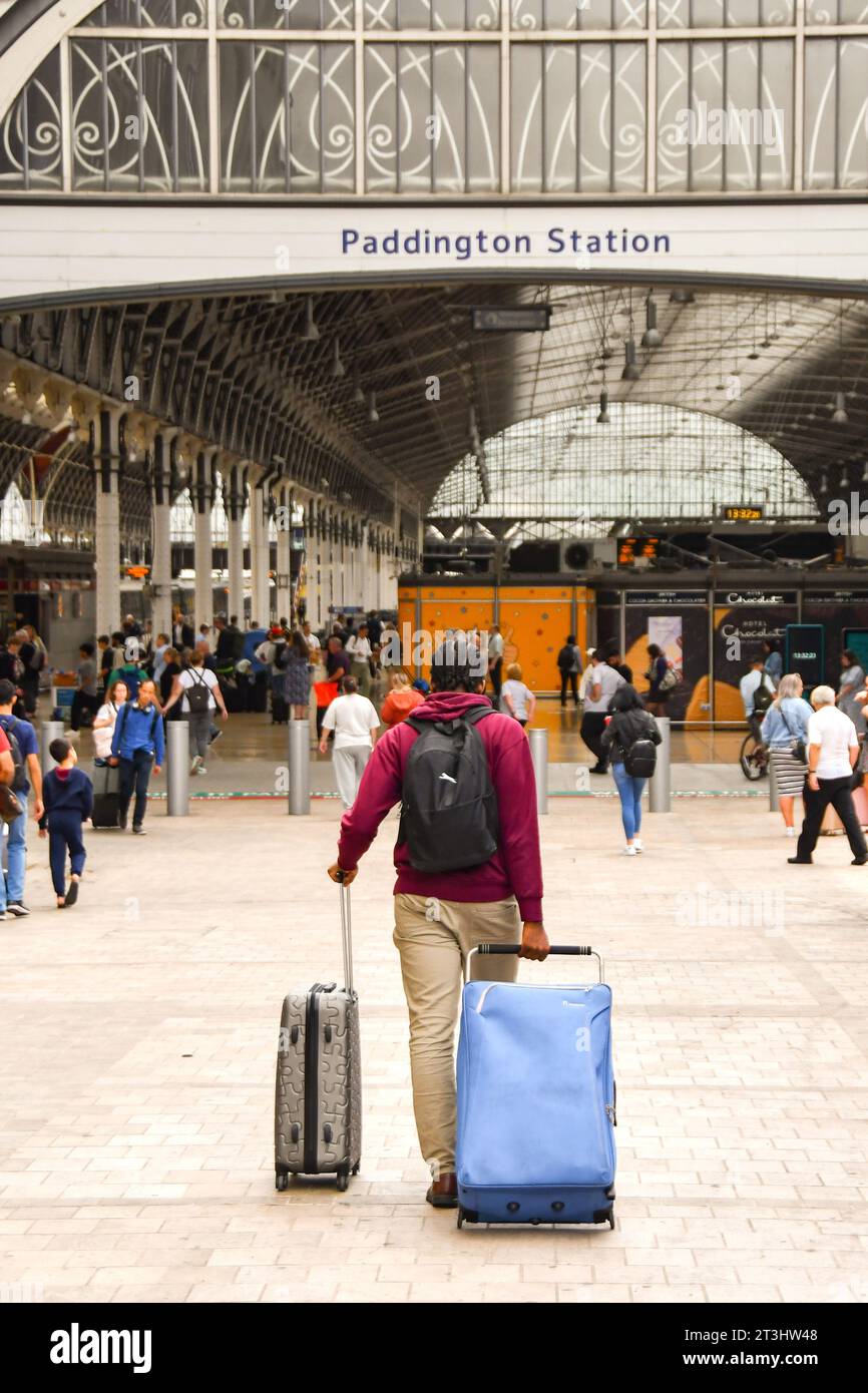 London, England, UK - 28 June 2023: Person with suitcases walking into ...