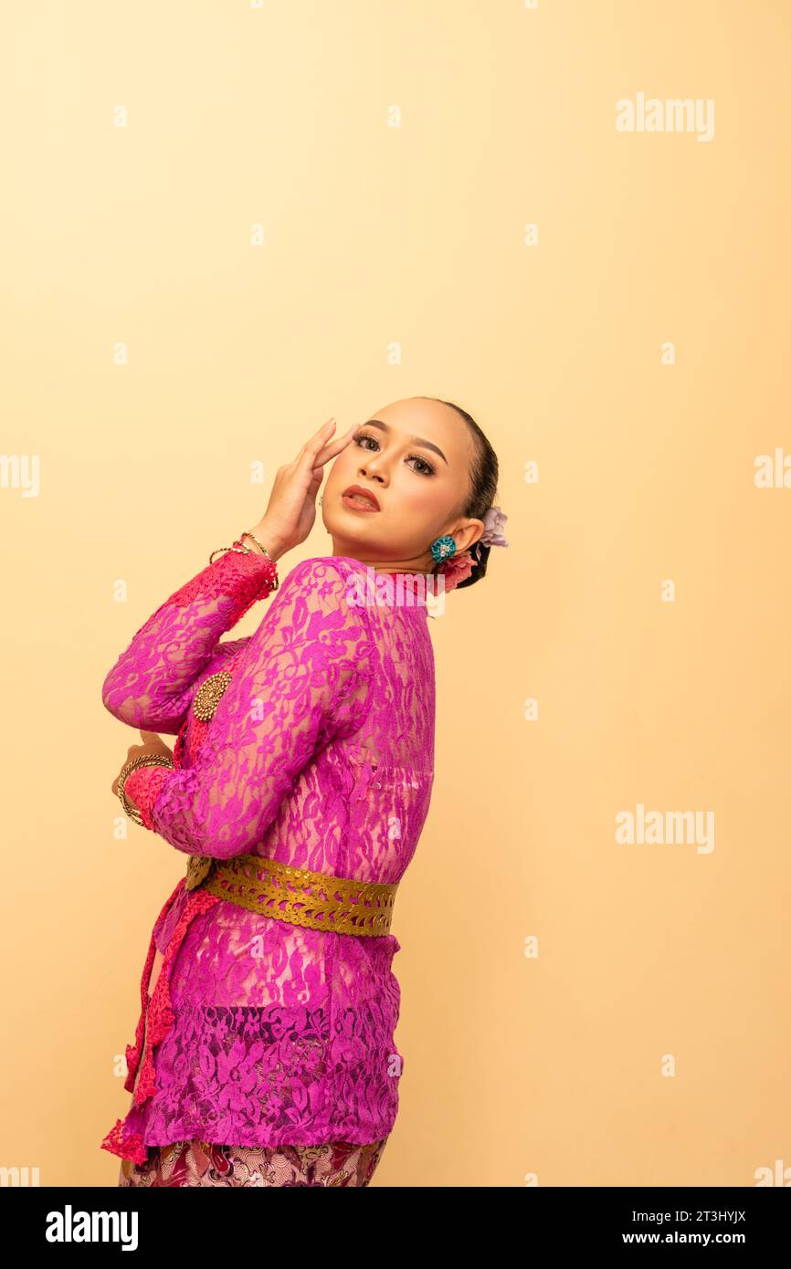 Javanese woman with black hair wearing makeup and a pink dress called ...