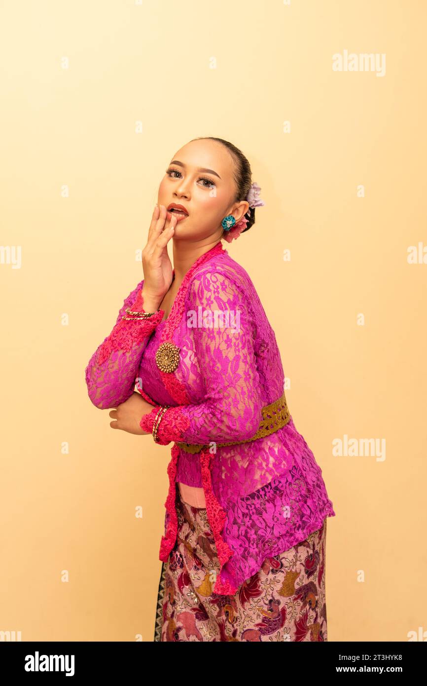 Javanese woman with black hair wearing makeup and a pink dress called ...