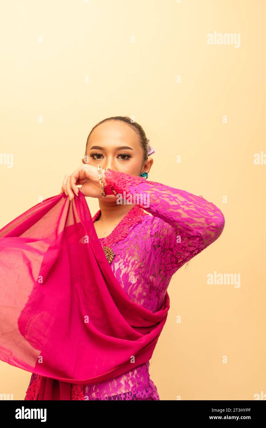 Javanese Woman Wearing Traditional Pink Dress Called Kebaya On The Indonesian Independence Day