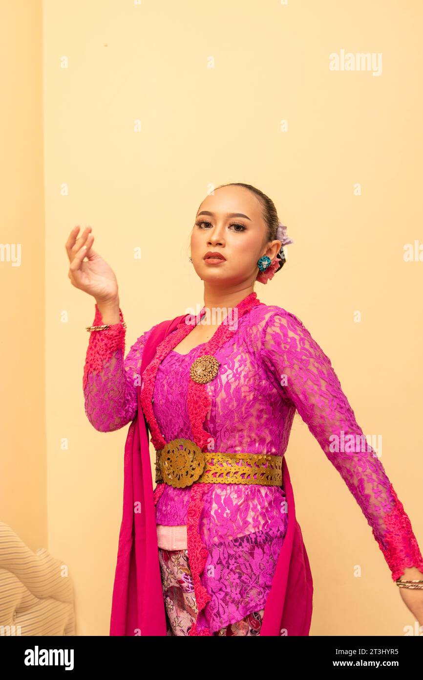 Javanese woman wearing traditional pink dress called kebaya on the ...