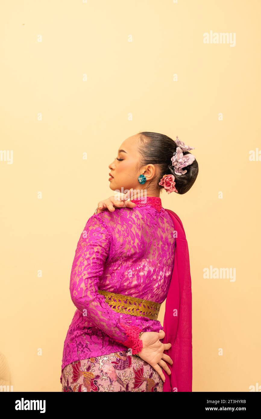 Javanese woman wearing traditional pink dress called kebaya on the ...