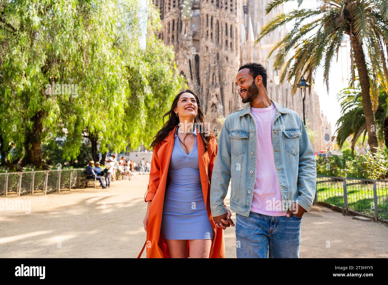 Multiracial beautiful happy couple of lovers dating at Sagrada Familia ...