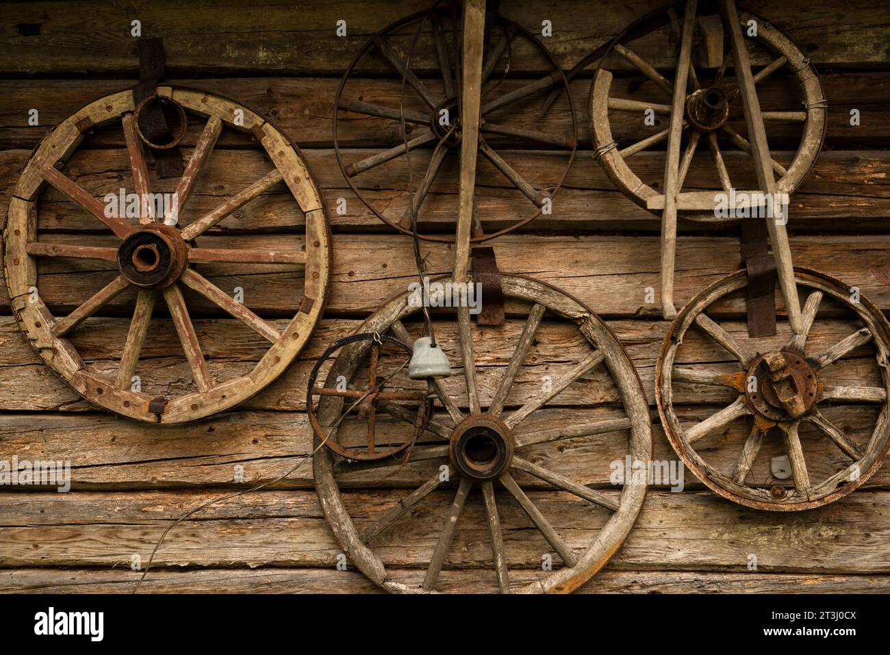 Old wheels from a cart on a wall Stock Photo - Alamy