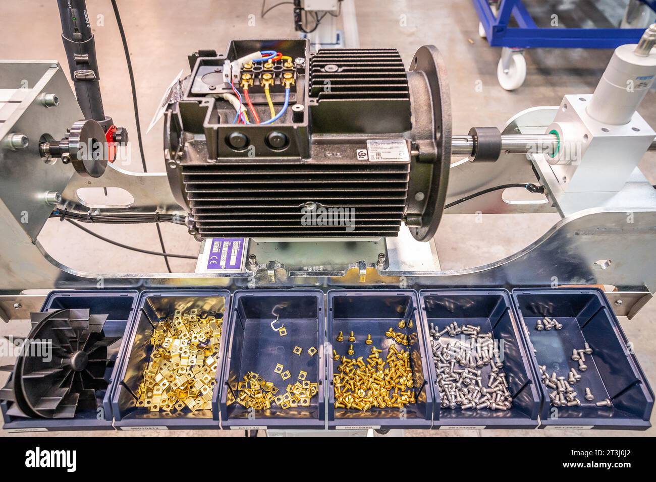 Electric motor assembly table at factory with bolts and nuts in ...