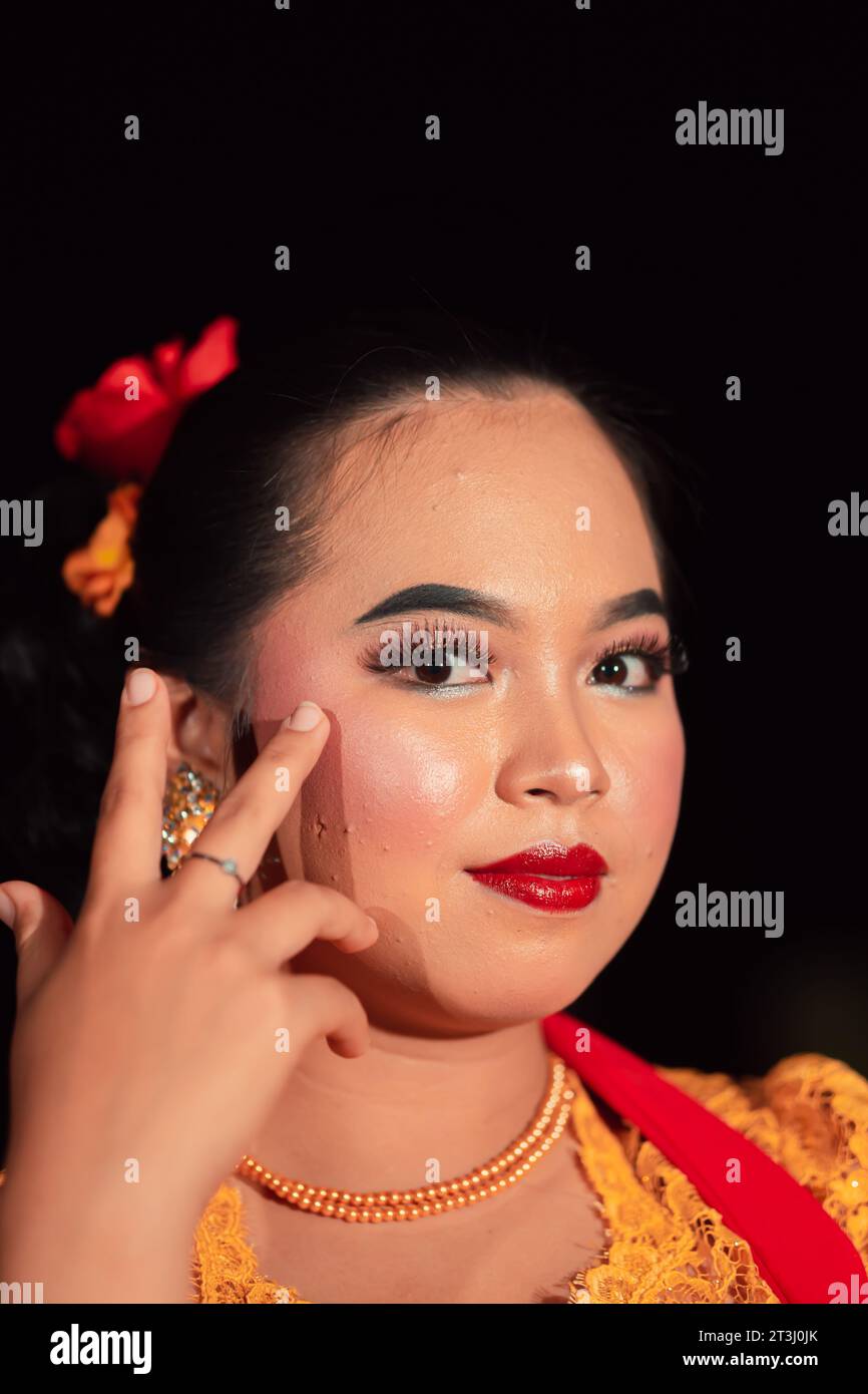 Beautiful face of an Asian woman with red lips and makeup in Indonesian ...
