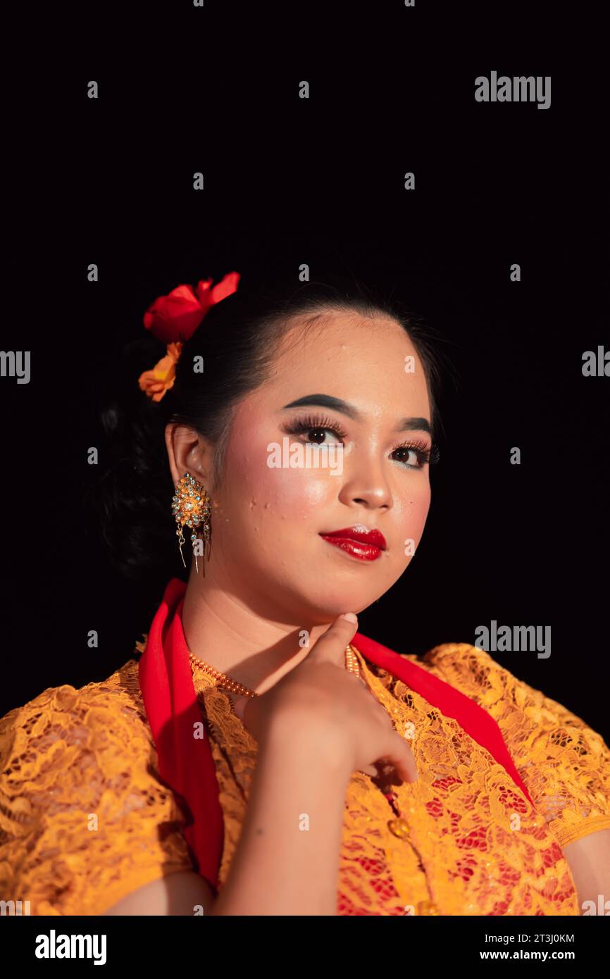 Beautiful face of an Asian woman with red lips and makeup in Indonesian ...