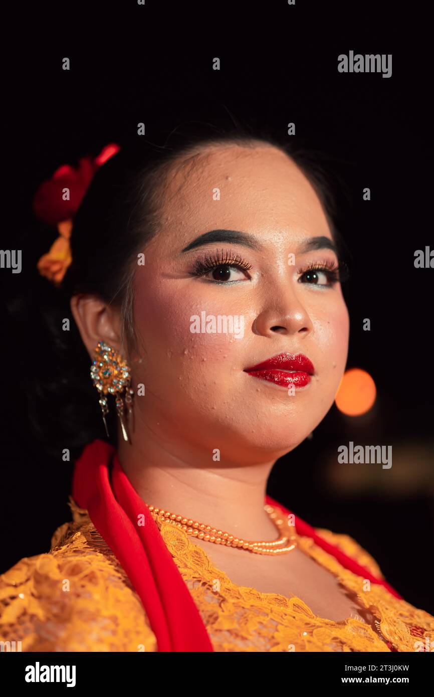 Beautiful face of an Asian woman with red lips and makeup in Indonesian ...