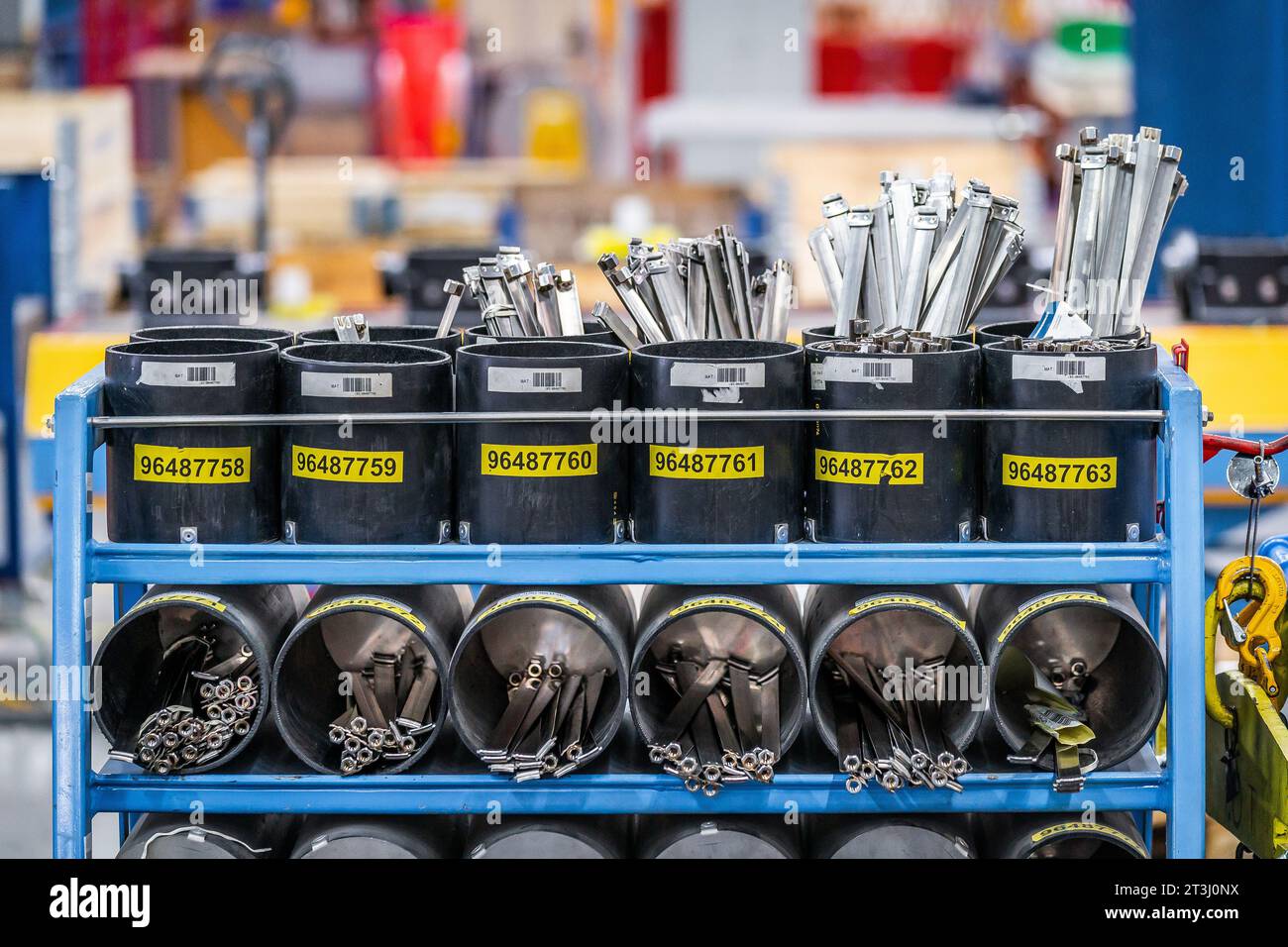 Assembly stack with bolts and nuts in numbered containers front view ...