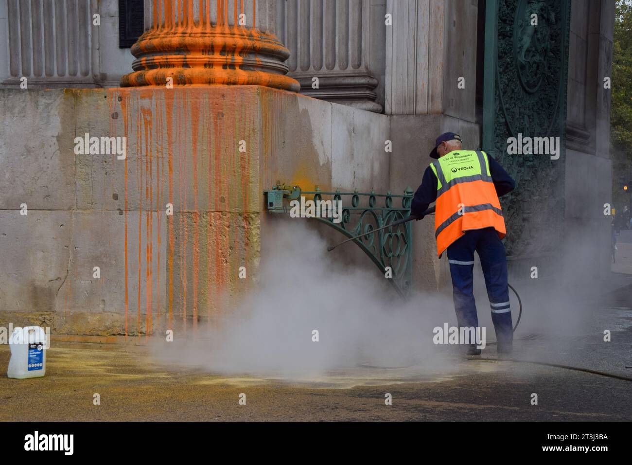 London, England, UK. 25th Oct, 2023. A worker cleans the orange paint ...