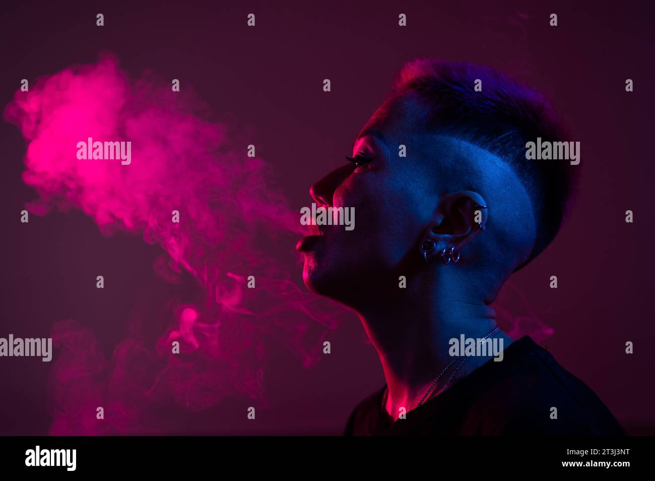 Profile Asian woman with short haircut smoking in neon light Stock ...