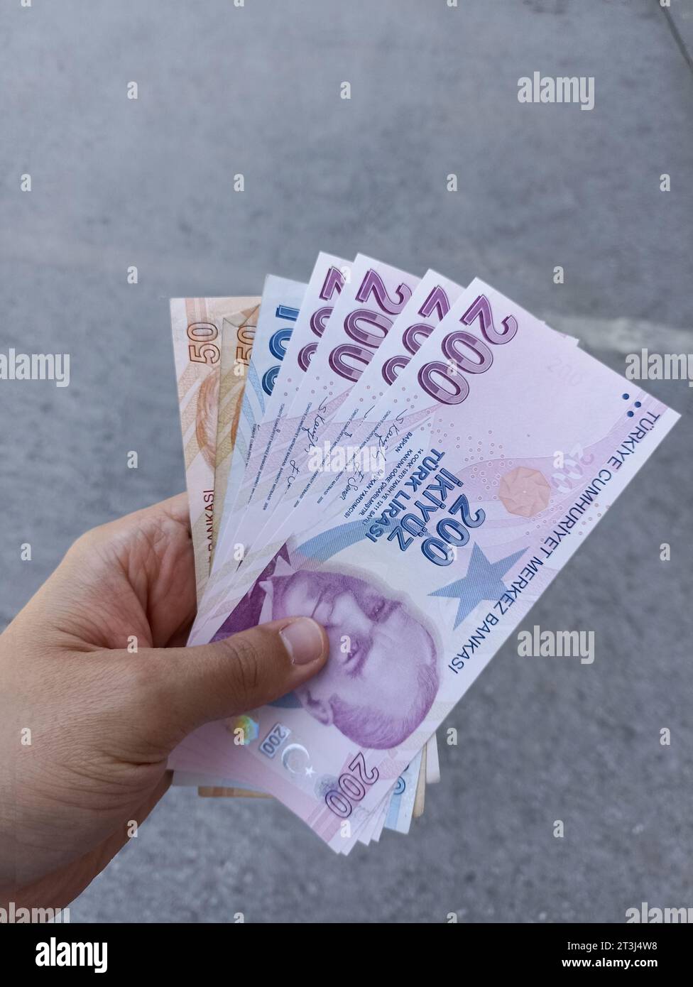 Turkish banknotes in male hand. 200 and 100 Turkish Liras Stock Photo ...