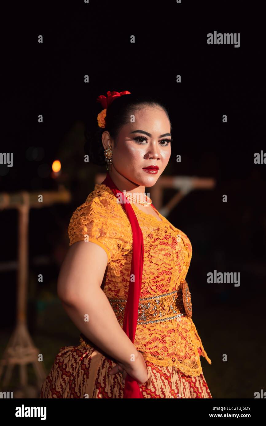 Brave Balinese woman poses with an angry expression while wearing a ...
