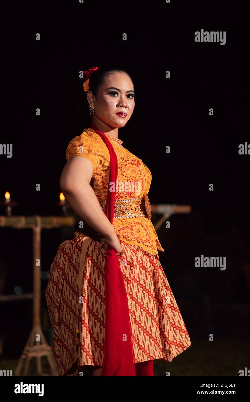 Brave Balinese woman poses with an angry expression while wearing a ...