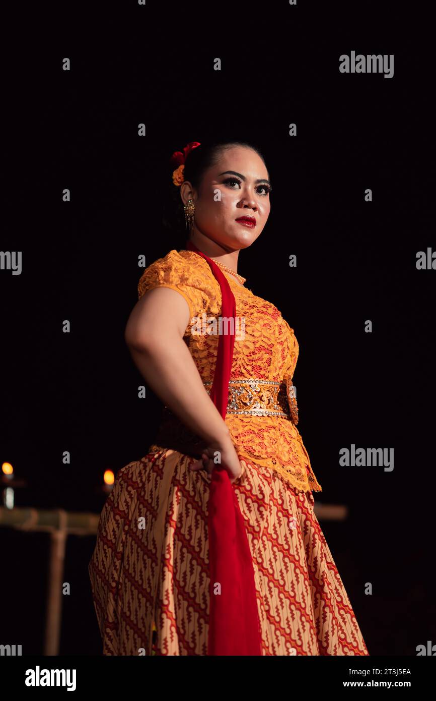 Brave Balinese woman poses with an angry expression while wearing a ...