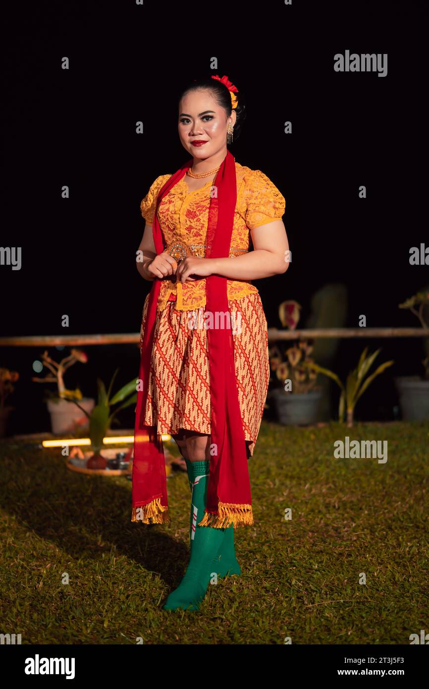 Cute Indonesian woman with red lips and a red scarf wearing a ...