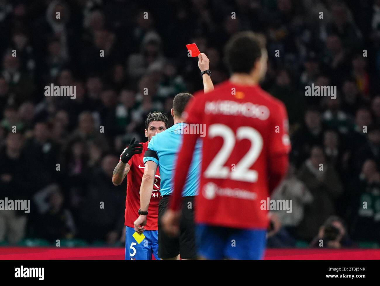 Referee Felix Zwayer shows a second yellow card to Atletico Madrid's ...