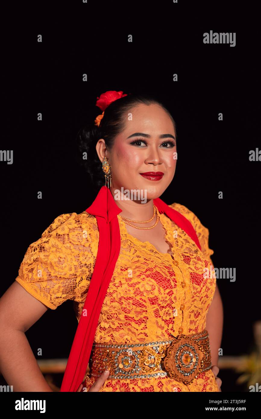 Exotic Indonesian women with red lips and makeup while wearing an ...