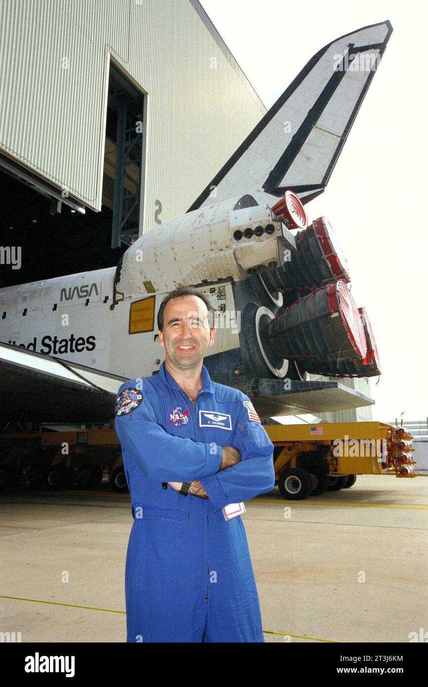 Astronaut Fernando (Frank) Caldeiro poses in front of the orbiter ...