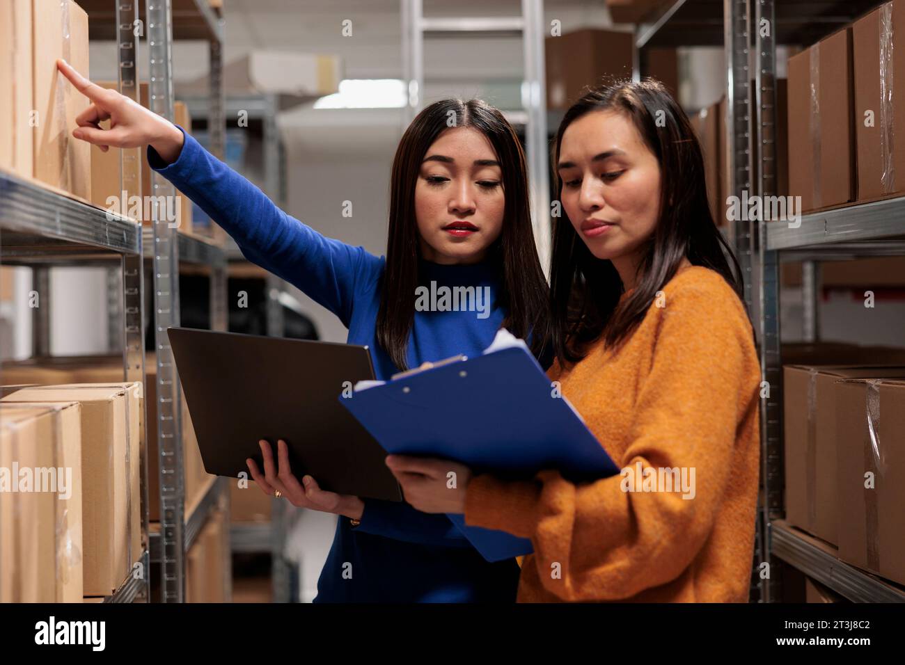 Warehouse worker and supply chain manager tracking inventory in storage ...