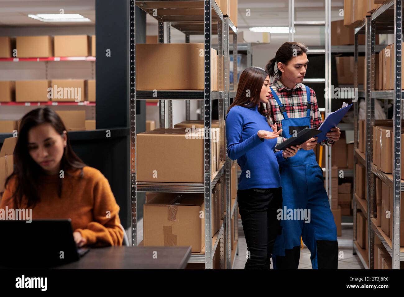 Storehouse managers comparing orders checklist on clipboard and digital ...