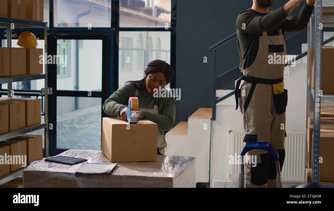 Dolly out shot of head of operations in warehouse supervising trainee ...