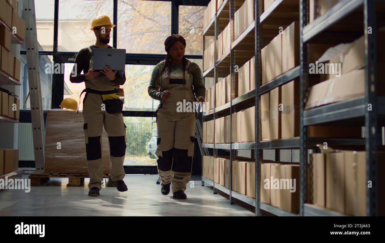 Experienced employees walking through warehouse aisles checking labels ...