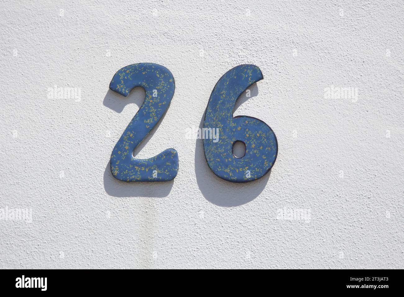 House number 26. Painted iron over whitewashed wall. Houses with ...