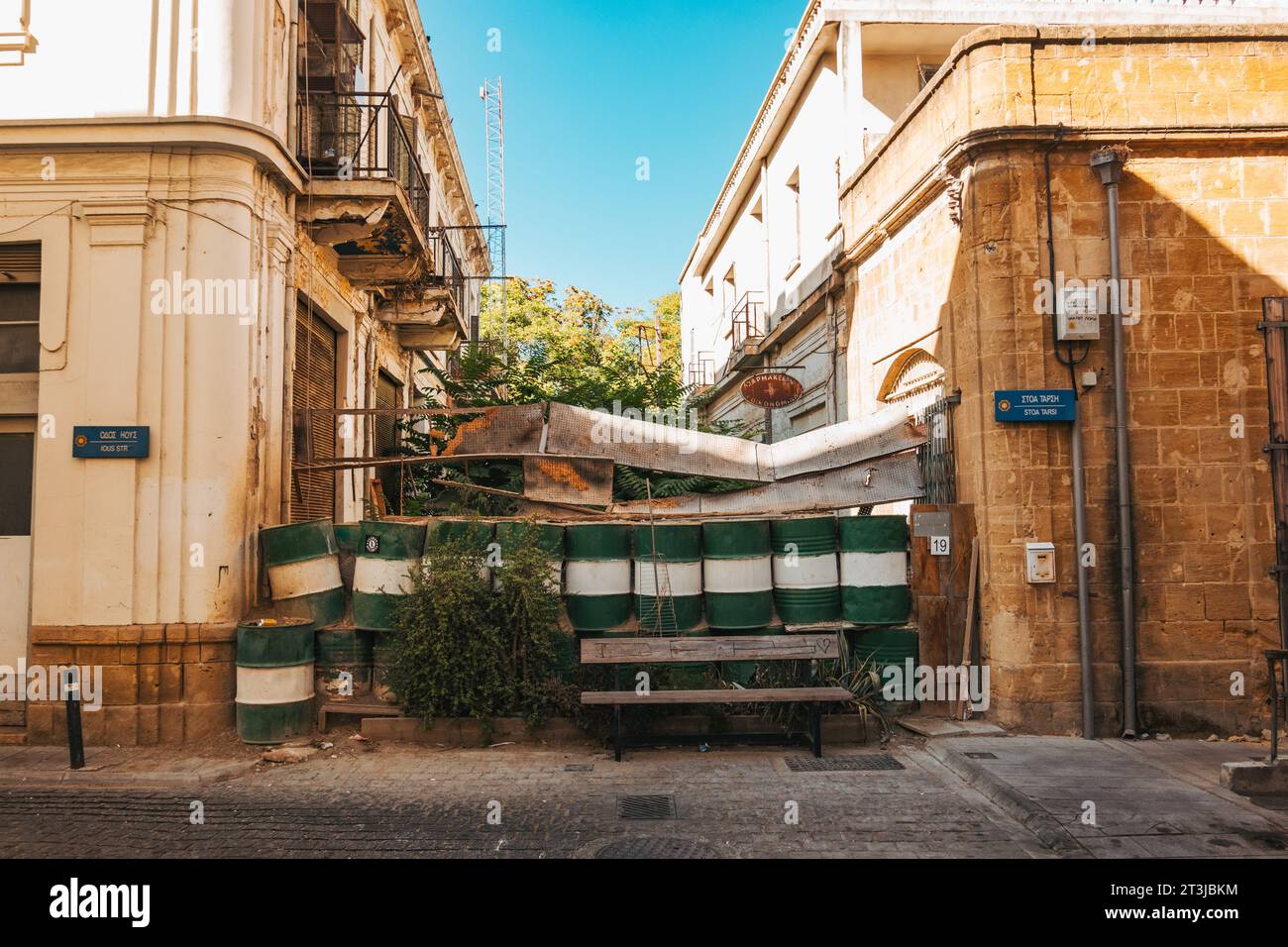 Metal drums filled with concrete create a wall as part of the "Green ...