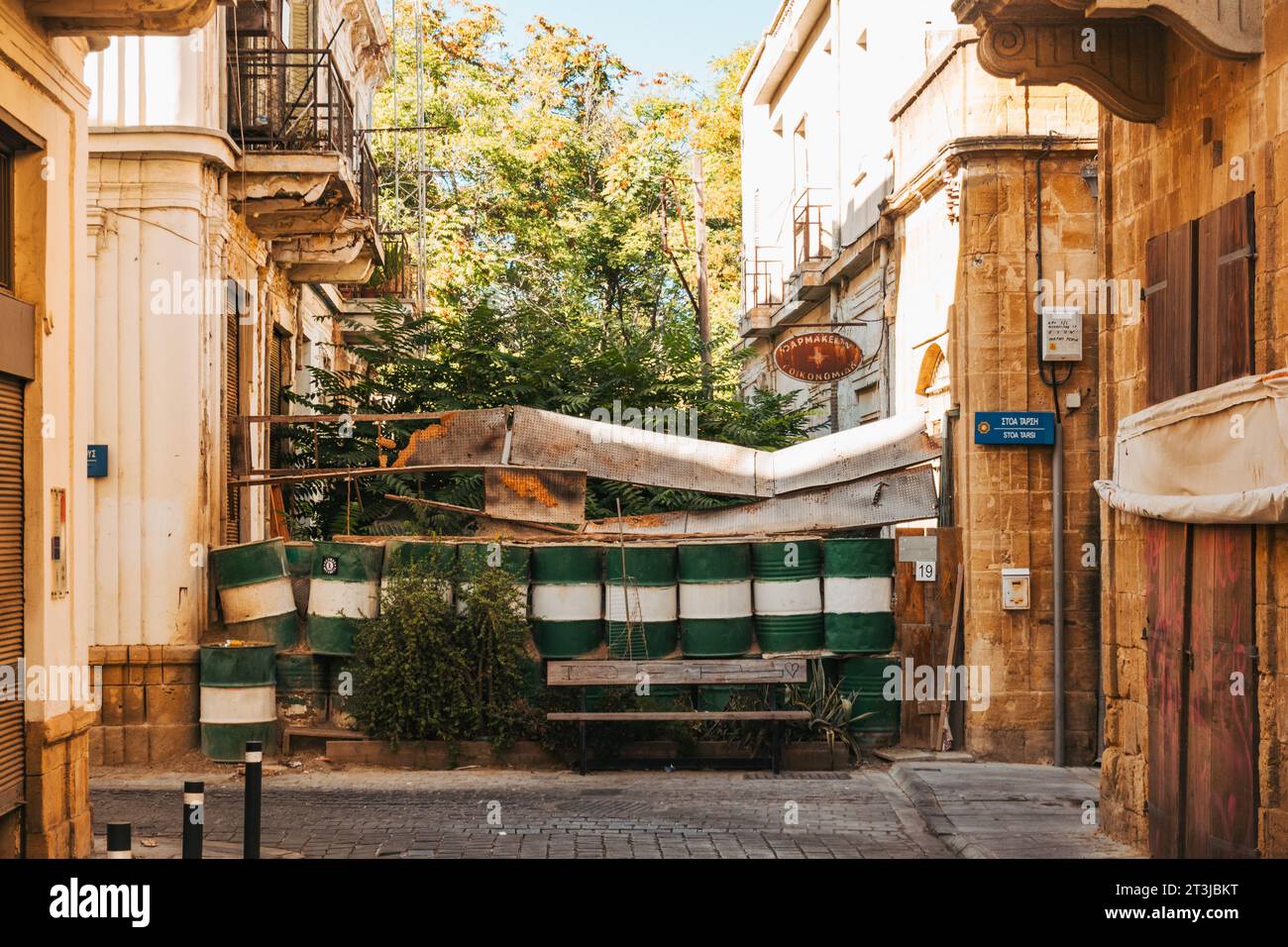 Metal drums filled with concrete create a wall as part of the "Green ...